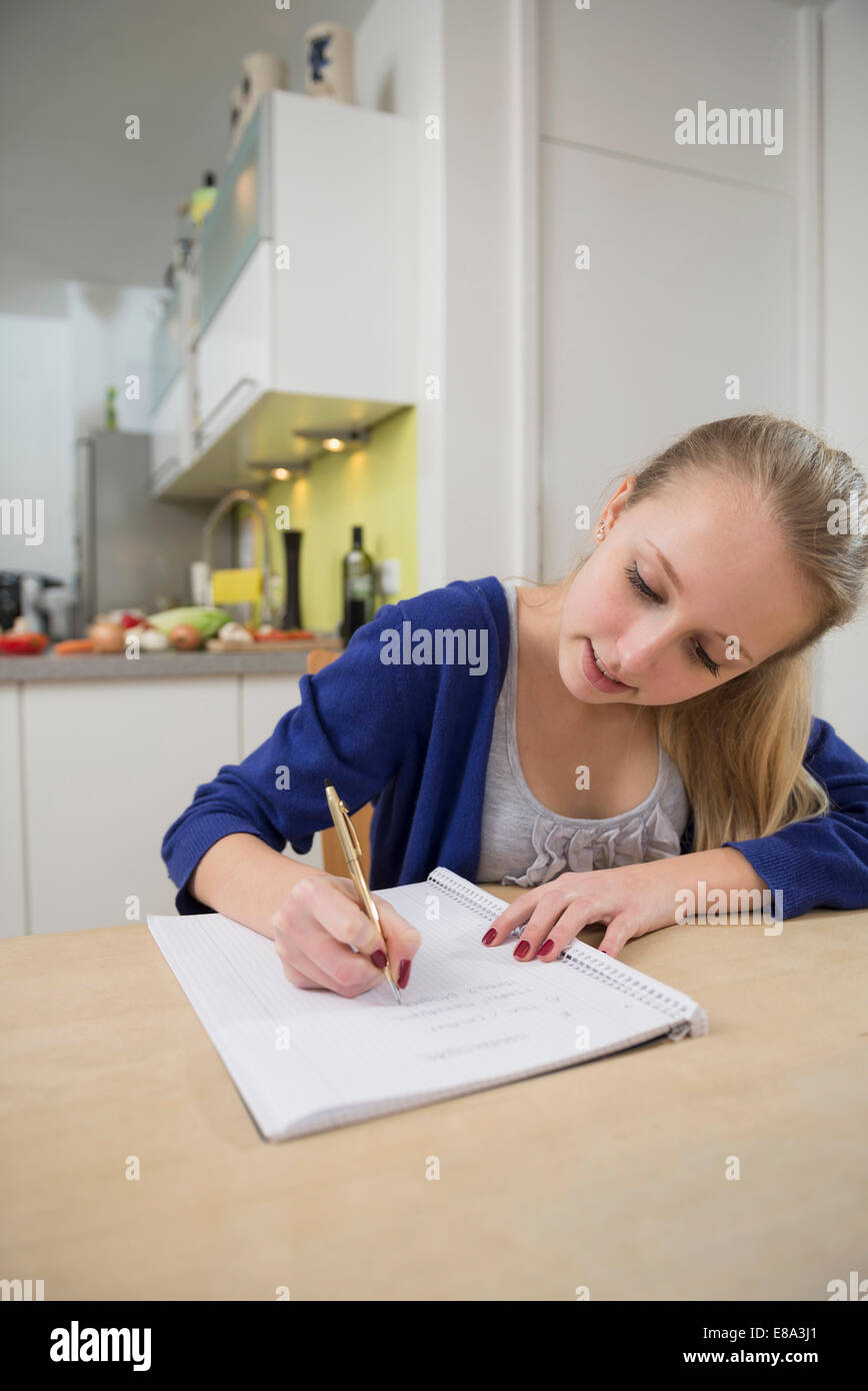 Teenage girl writing notes Stock Photo - Alamy