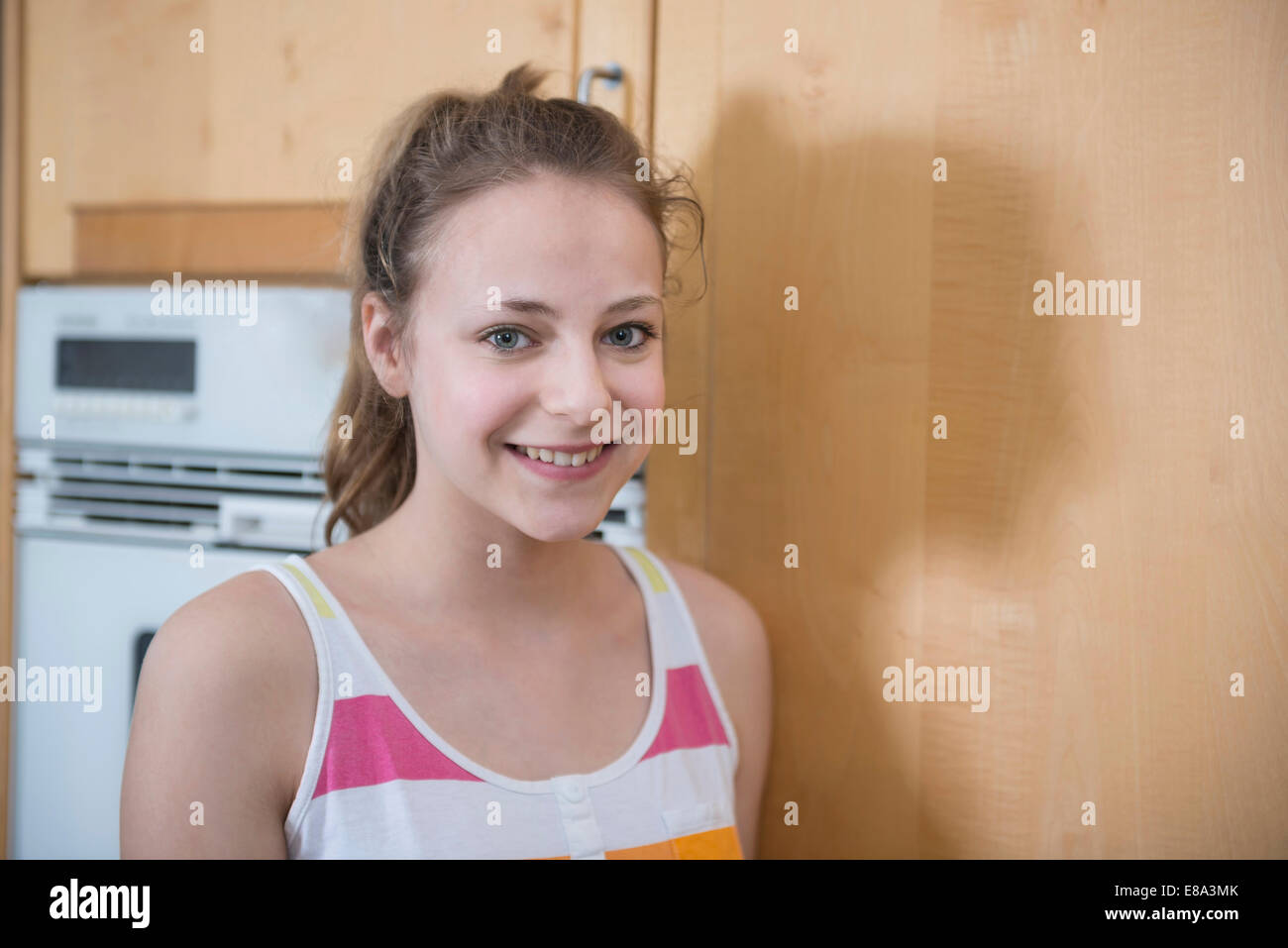 Portrait of girl in kitchen, smiling Stock Photo - Alamy