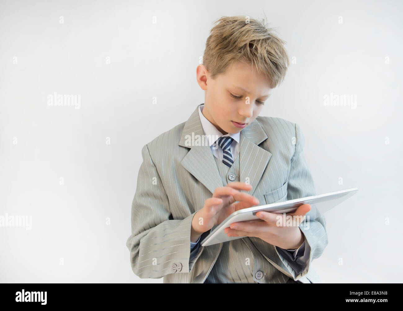 Boy using digital tablet against white background, close up Stock Photo ...