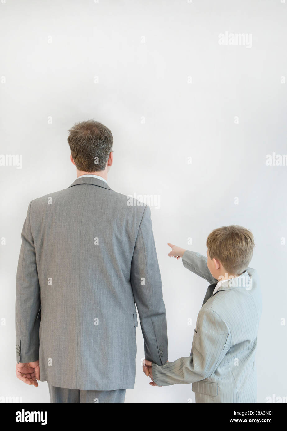 Son showing something to his father Stock Photo - Alamy