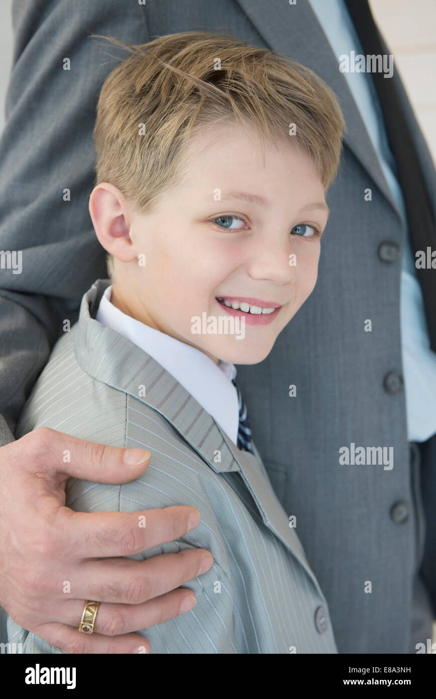 Boy smiling beside father, close up Stock Photo - Alamy