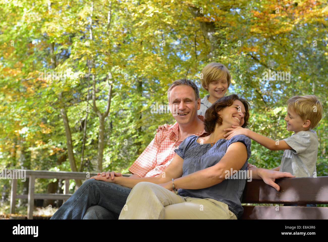 Family playing around bench, smiling, Bavaria, Germany Stock Photo - Alamy