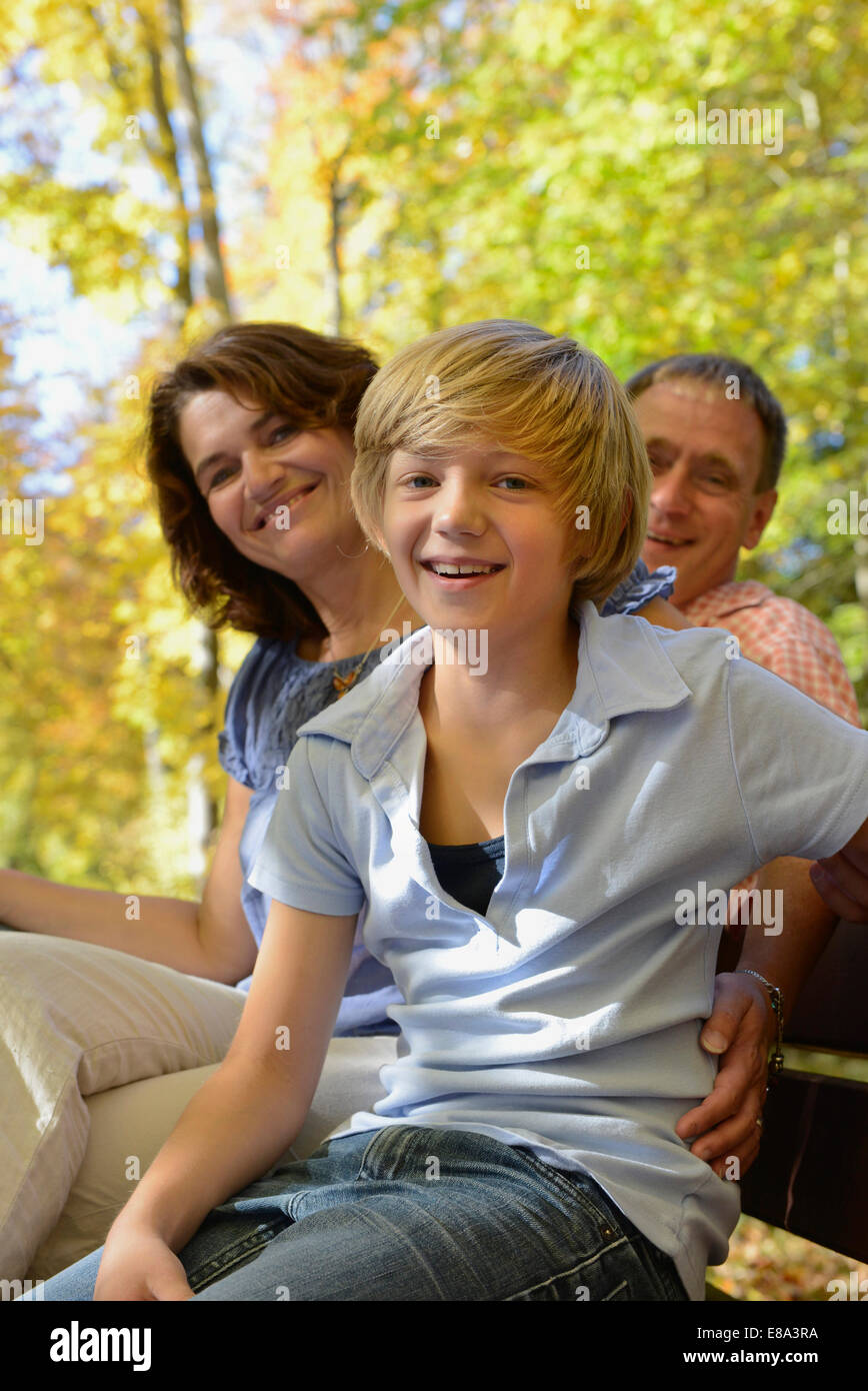Family sitting on bench, smiling, portrait, Bavaria, Germany Stock ...