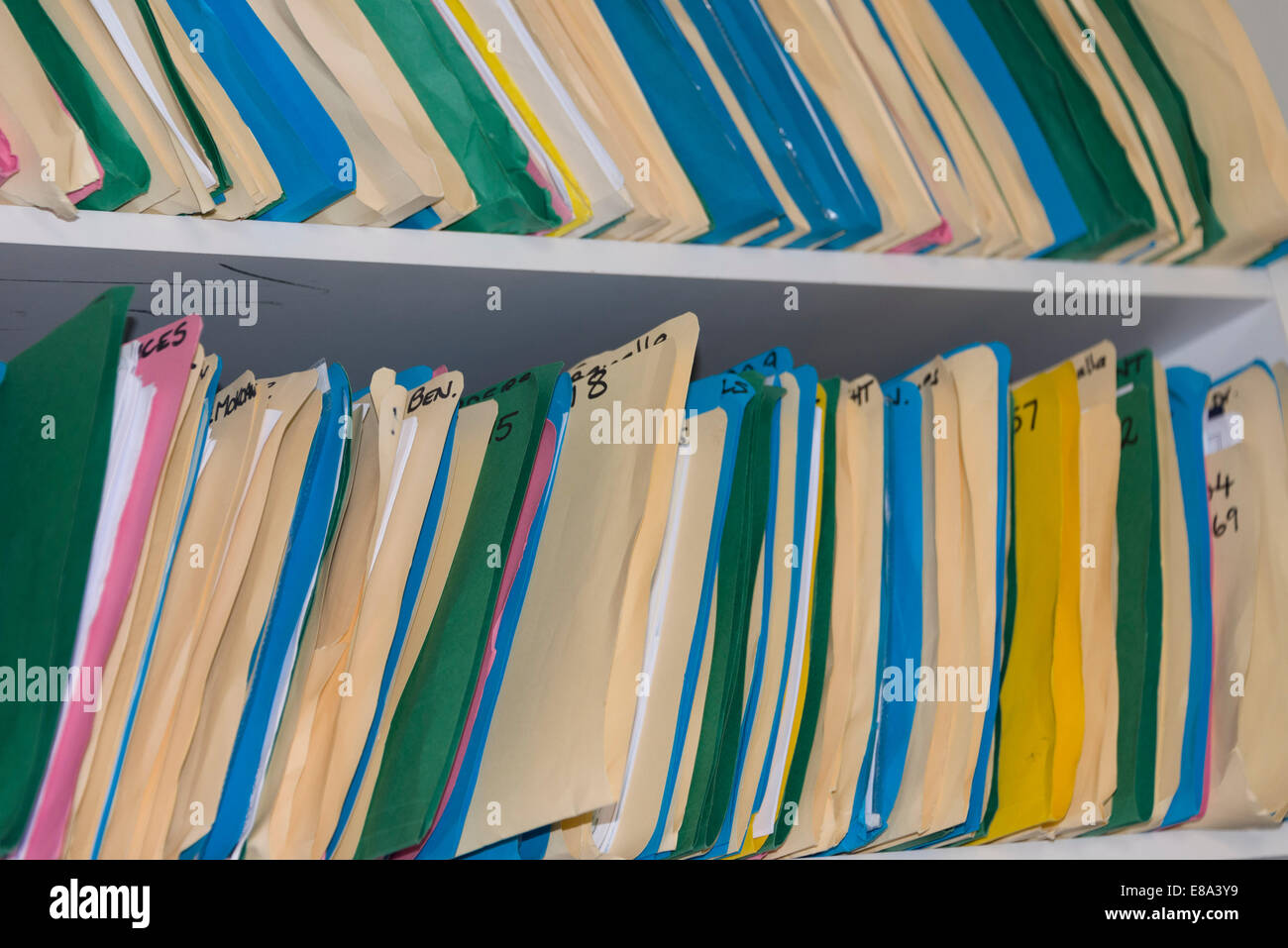 files in office on shelves stacked colour offices files Stock Photo - Alamy