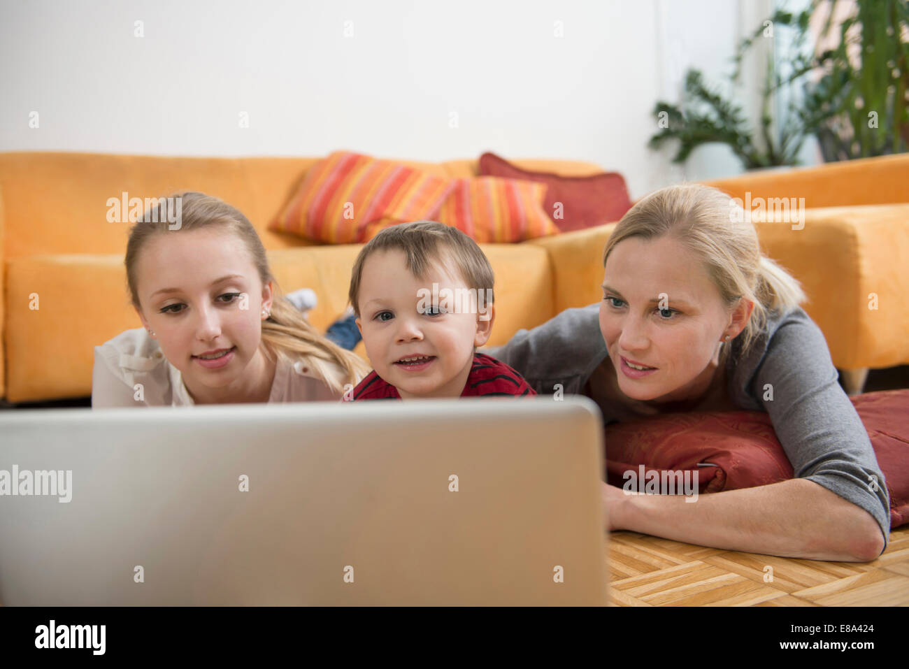 Family using laptop in living room Stock Photo - Alamy