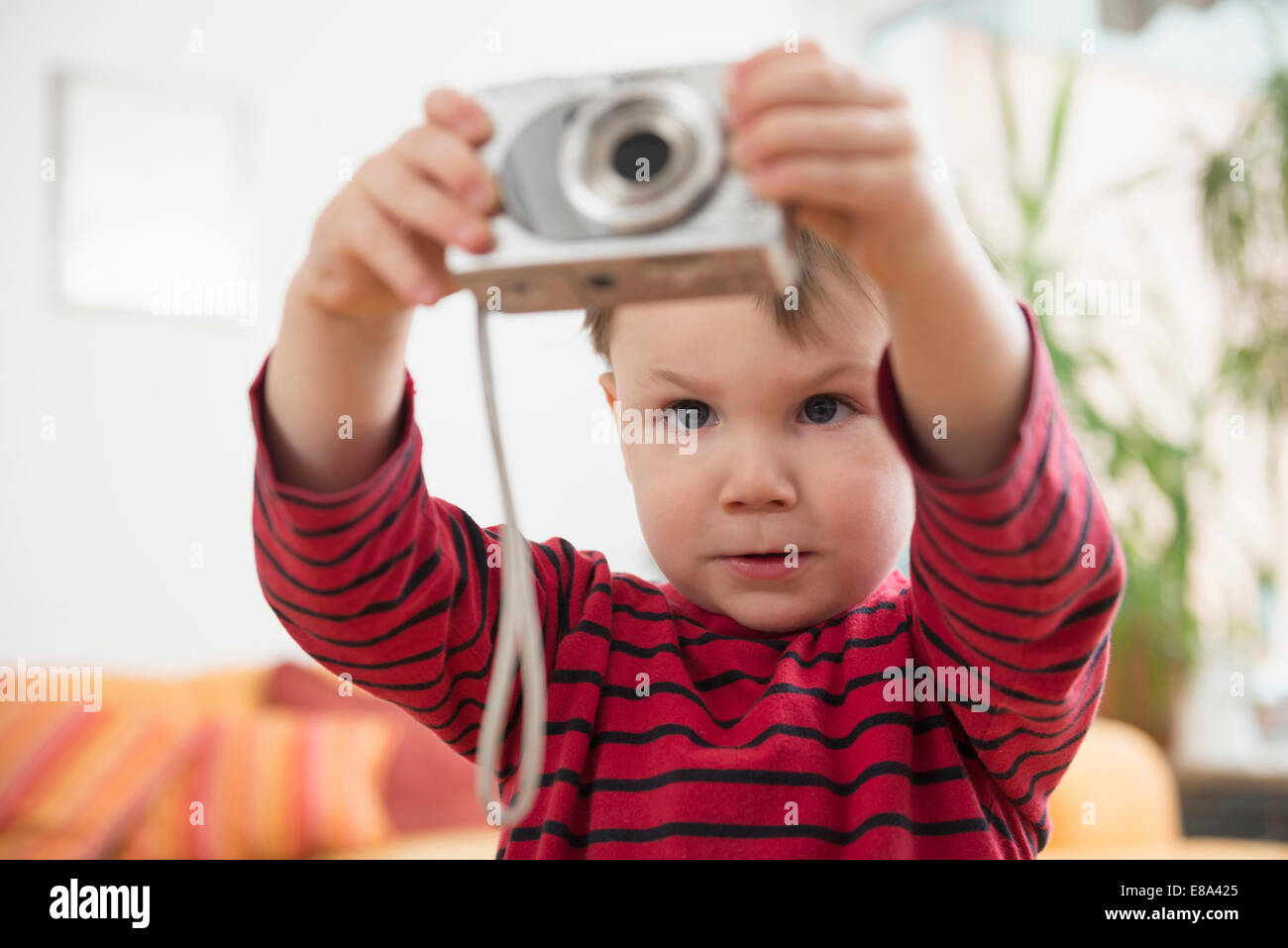 Boy taking pictures with camera Stock Photo - Alamy