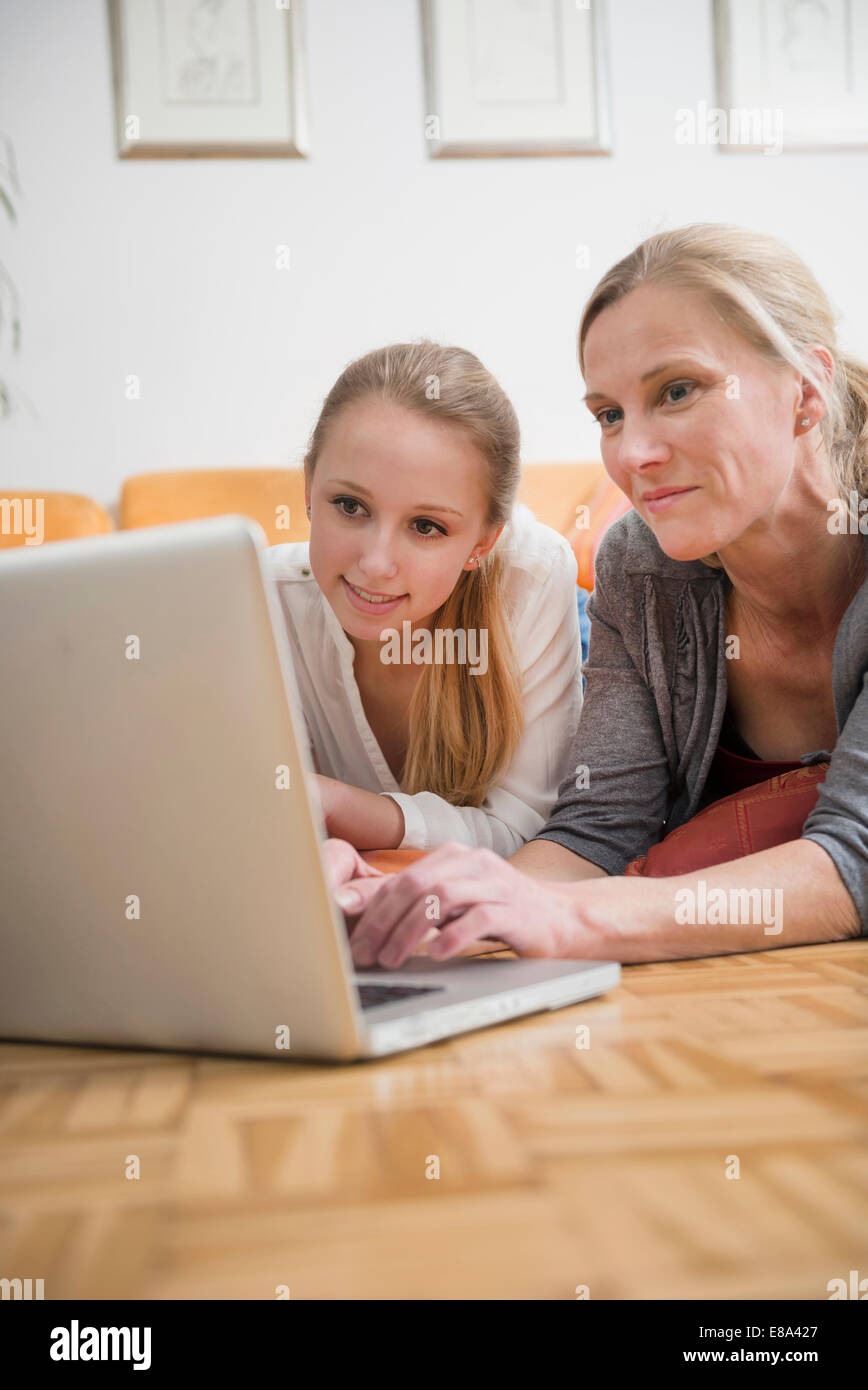 Mother teenage daughter looking laptop hi-res stock photography and ...