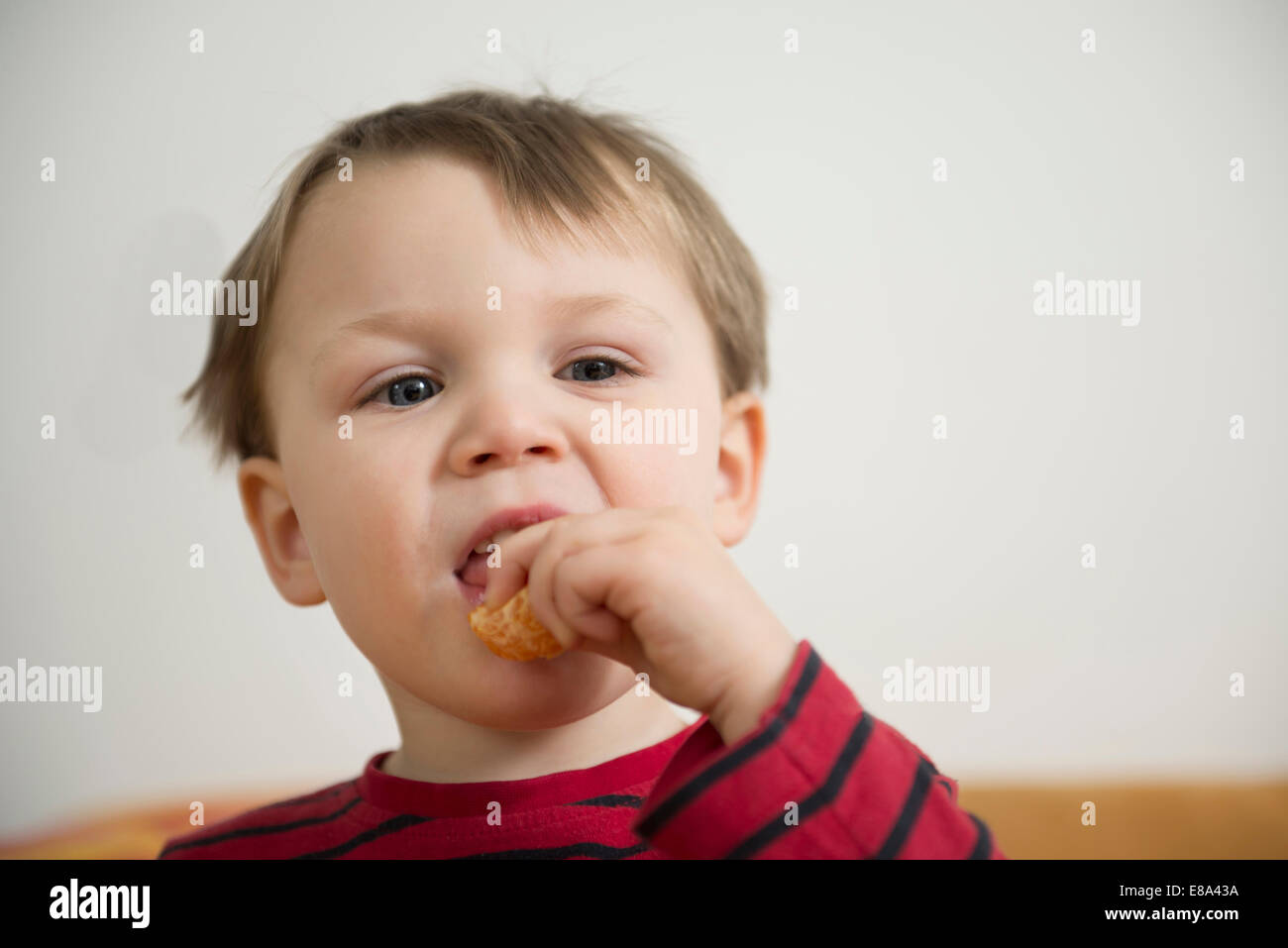 Boy eating mandarin Stock Photo - Alamy