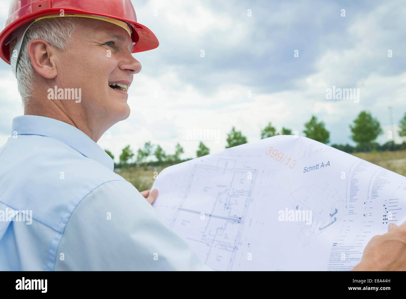 Architect checking construction plan Stock Photo - Alamy
