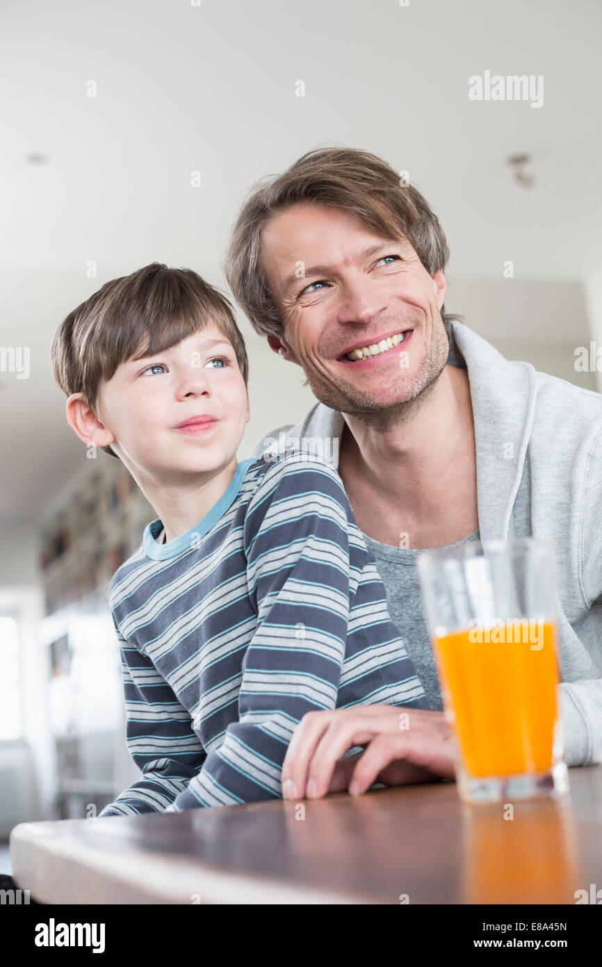 Father and son looking away, smiling Stock Photo - Alamy