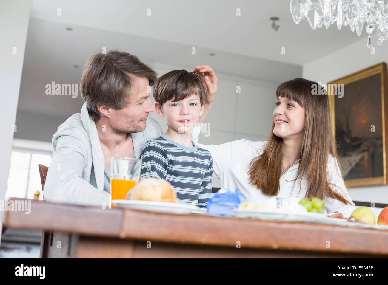 Family at breakfast table, smiling Stock Photo - Alamy