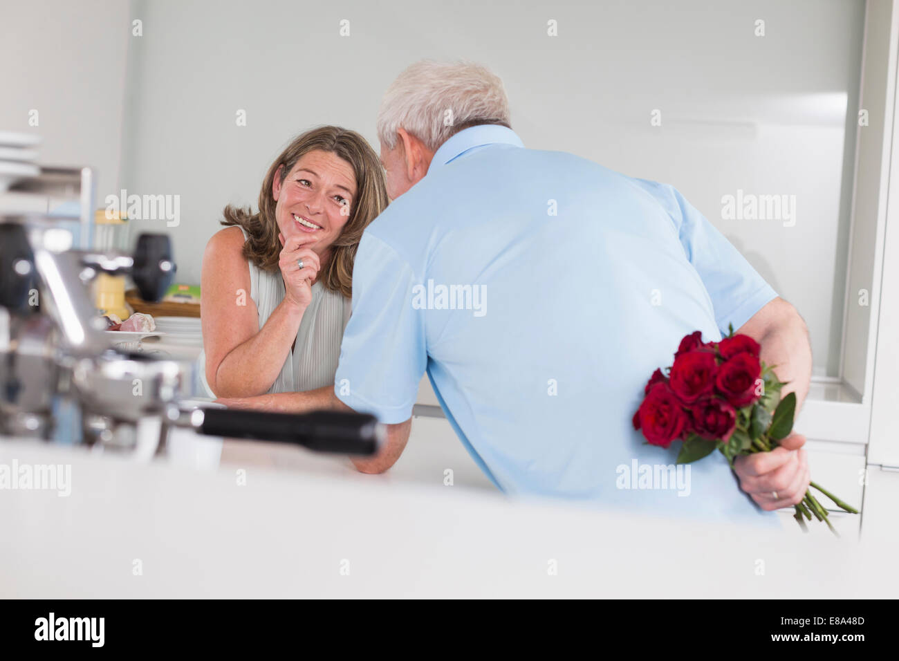 Senior man giving red roses to woman Stock Photo - Alamy