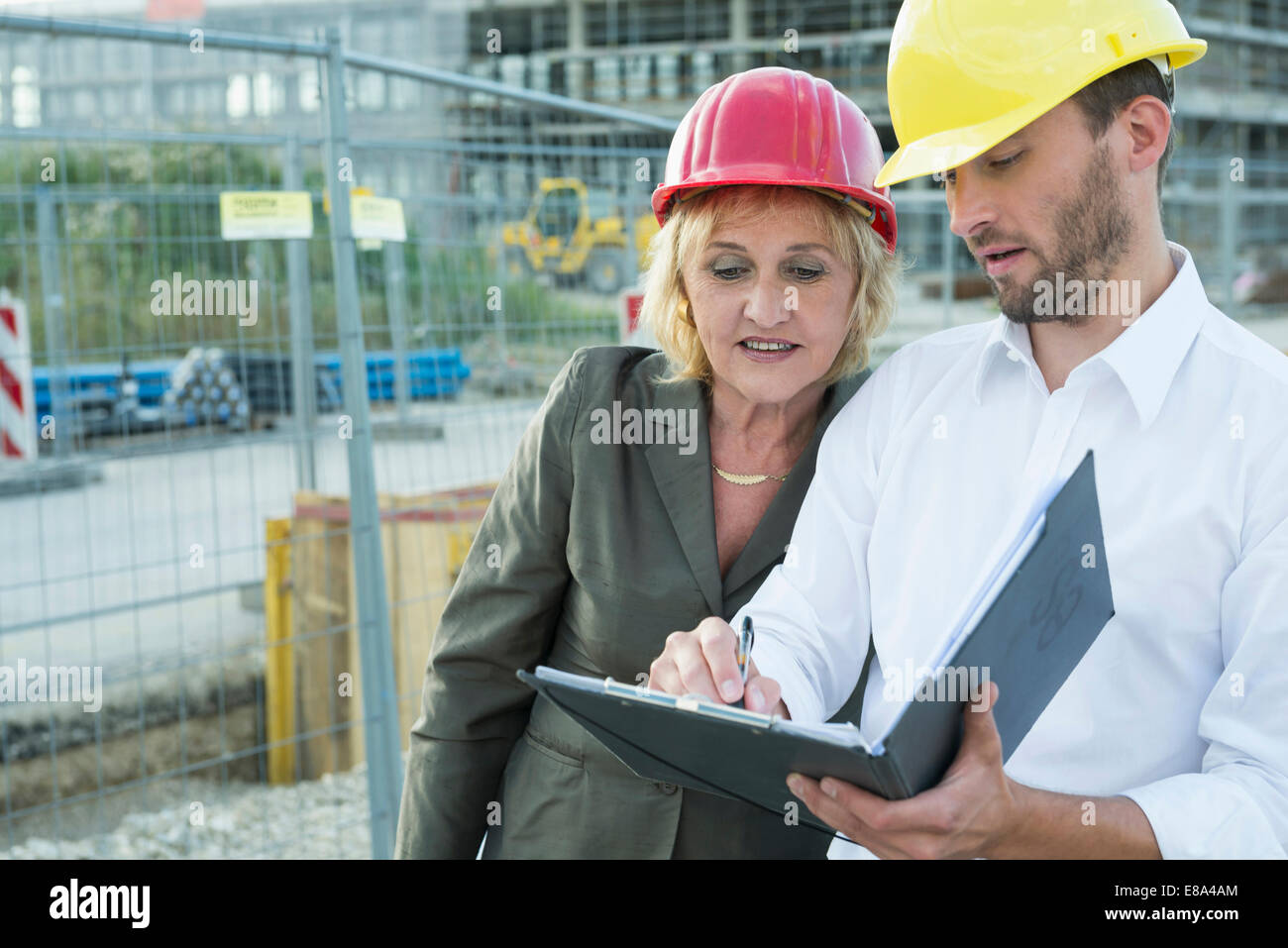 Architect on site with customer Stock Photo - Alamy