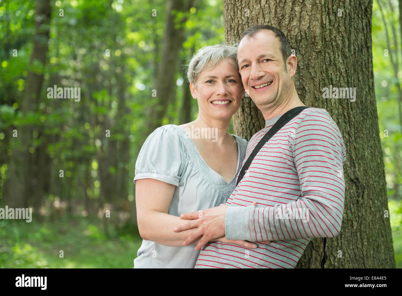 Couple leaning on tree hi-res stock photography and images - Alamy