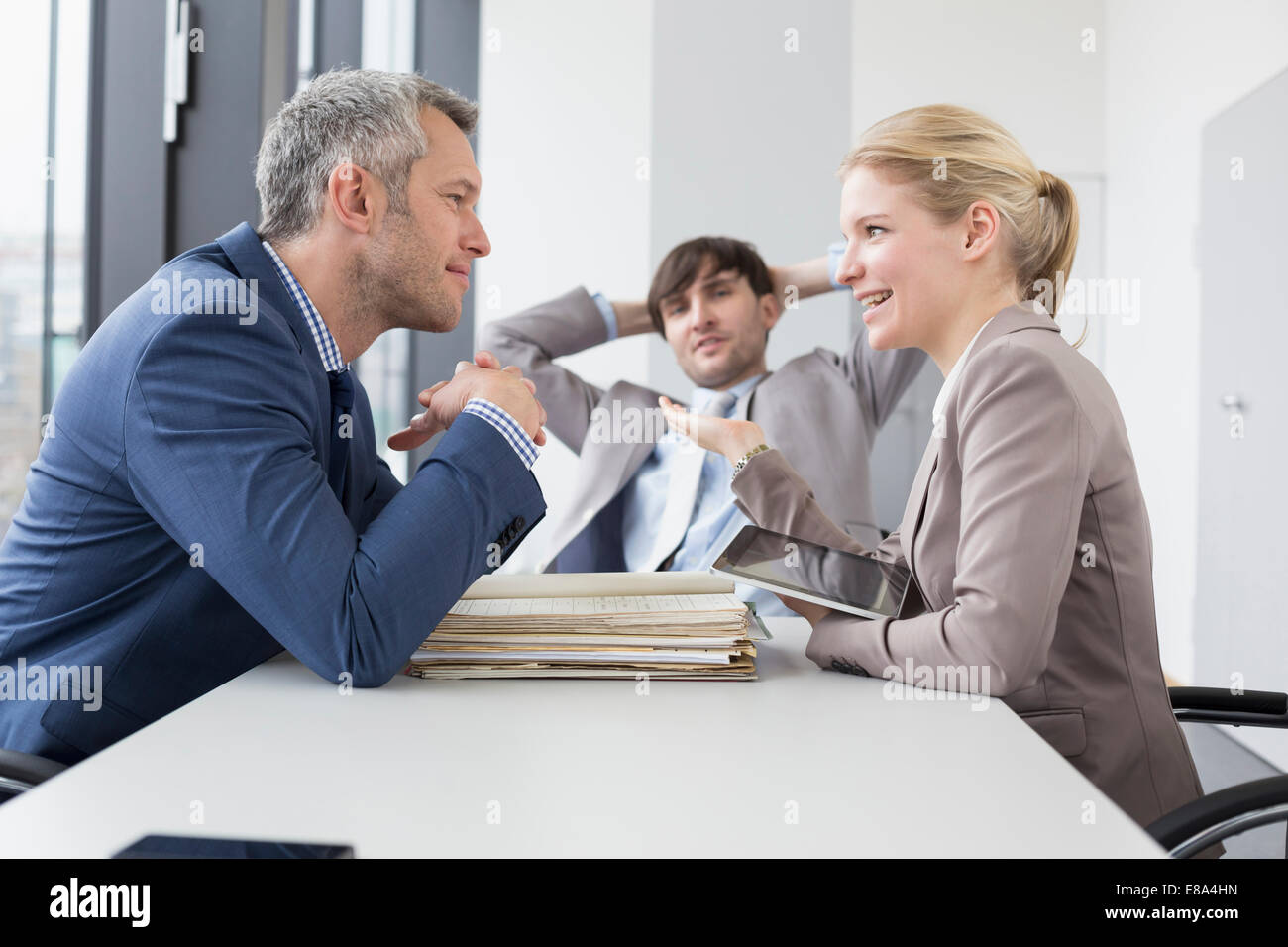 Colleagues having meeting in office, smiling Stock Photo - Alamy