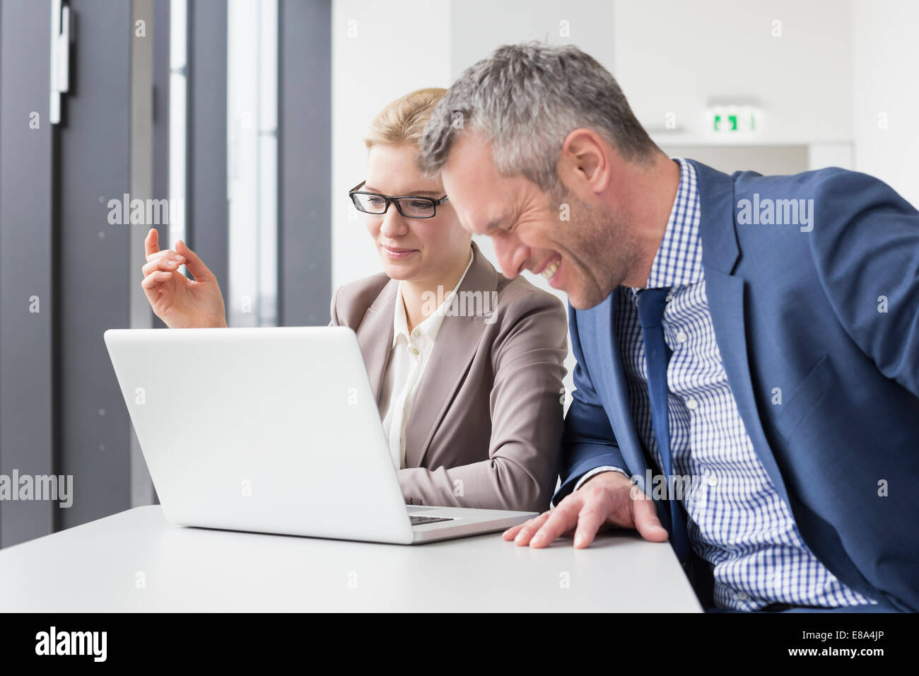 Colleagues having meeting in office, smiling Stock Photo - Alamy