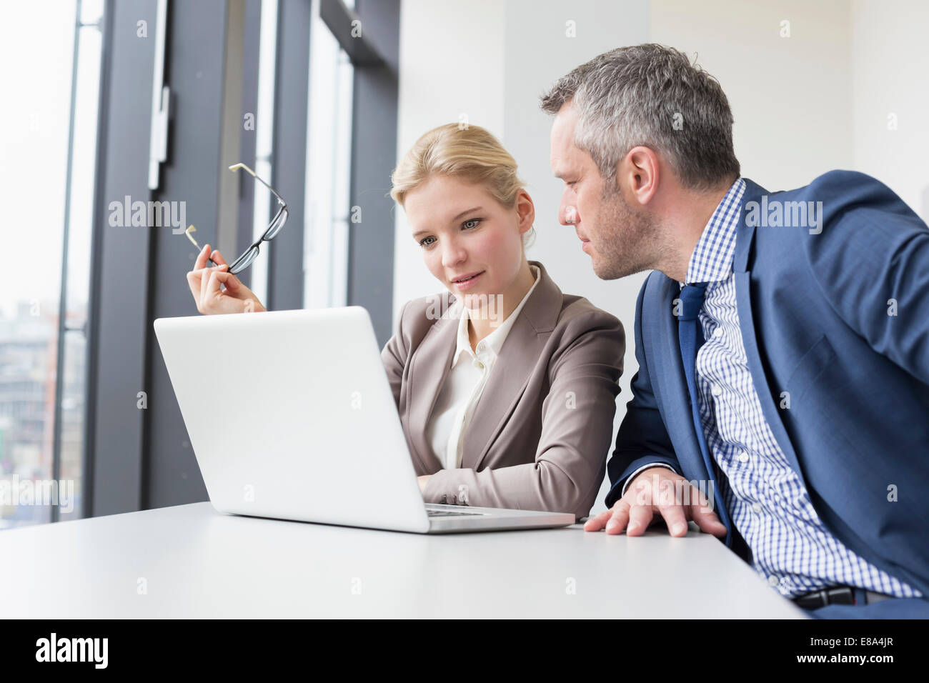 Colleagues having meeting in office, smiling Stock Photo - Alamy