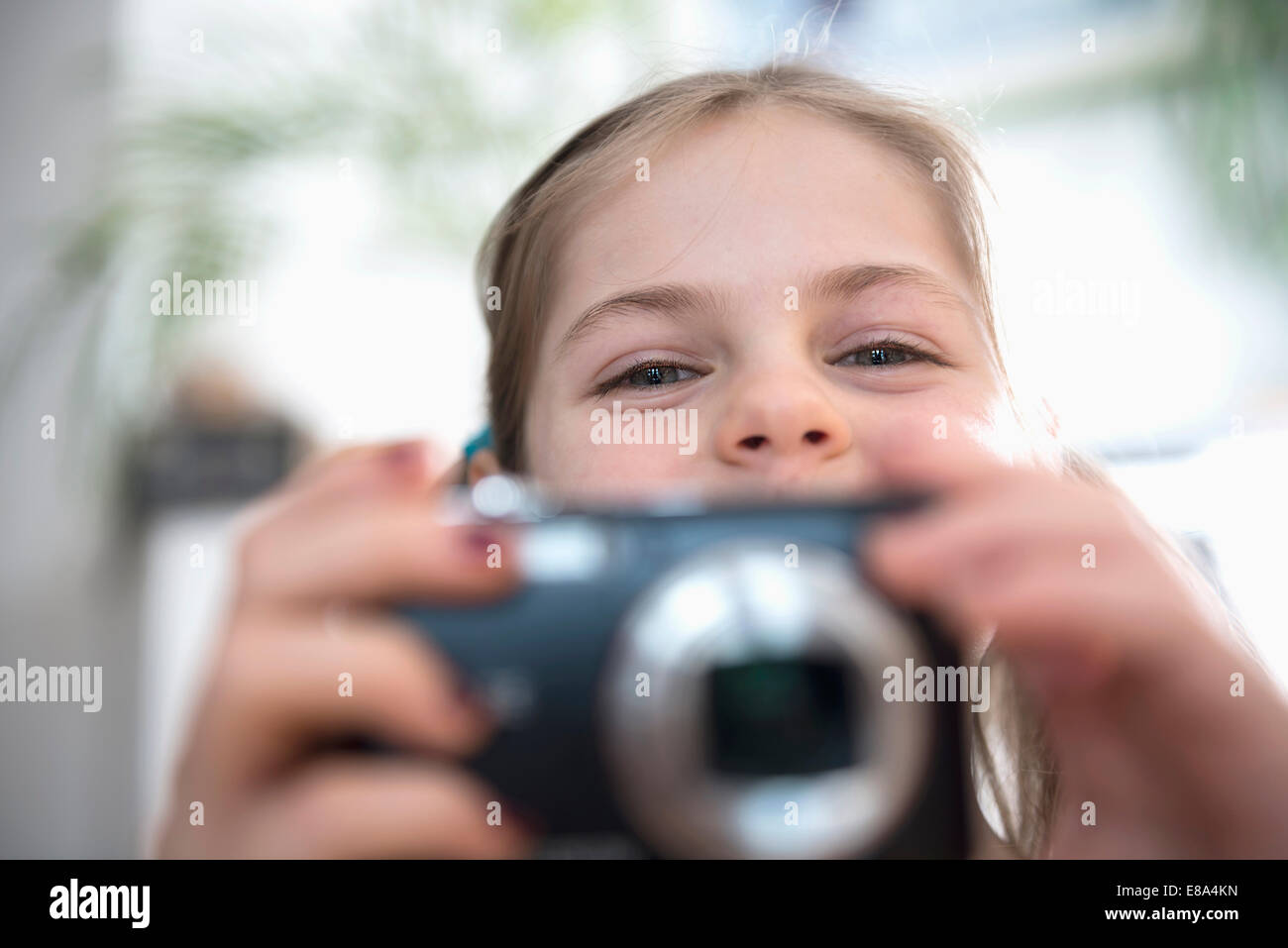 Portrait of girl with camera, smiling Stock Photo - Alamy