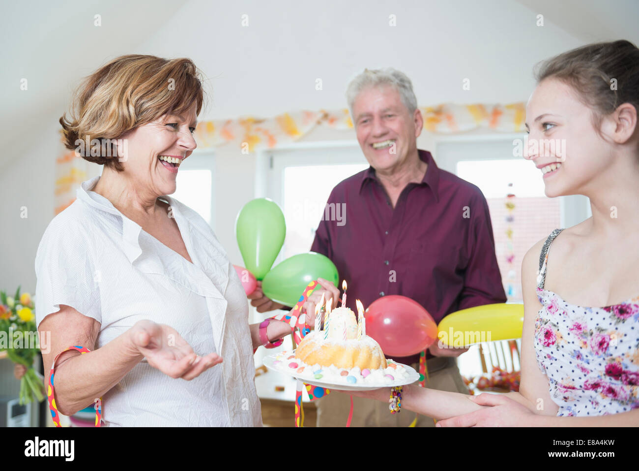 Family celebrating birthday party, smiling Stock Photo - Alamy