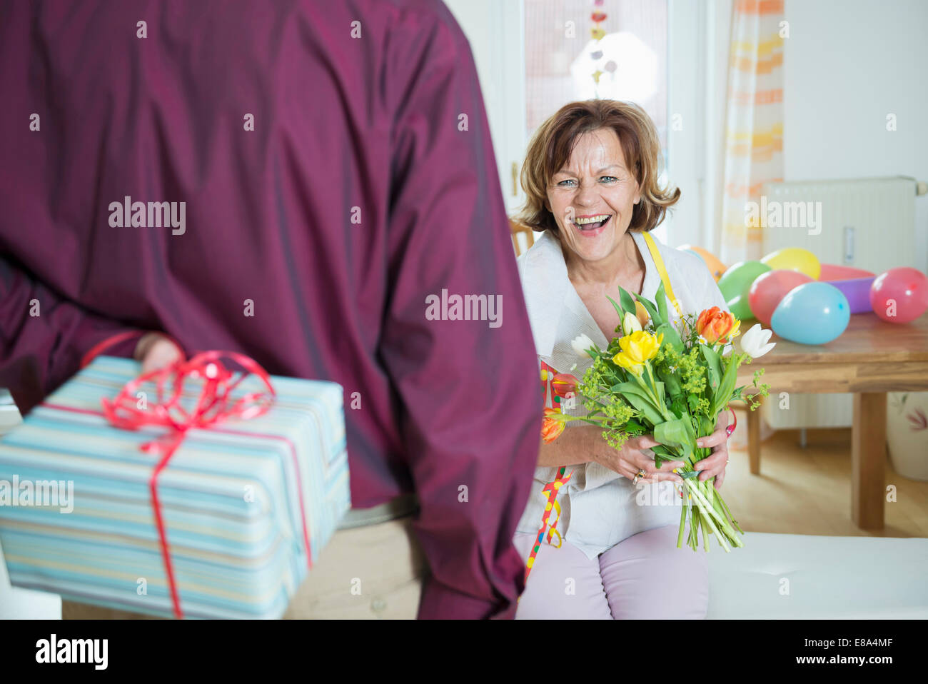 Senior man hand over present to woman on birthday, smiling Stock Photo ...