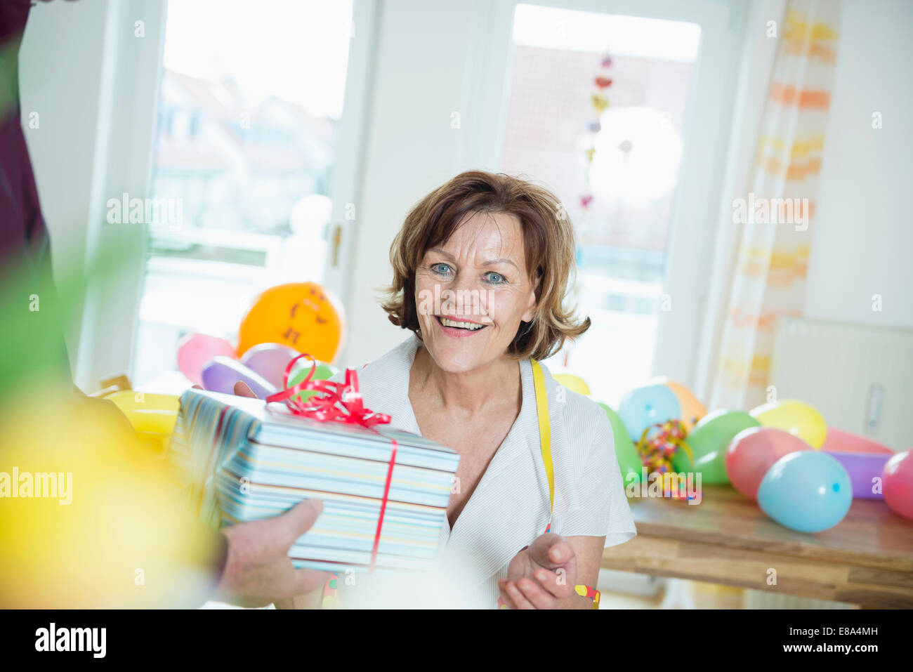 Senior man hand over present to woman on birthday, smiling Stock Photo ...