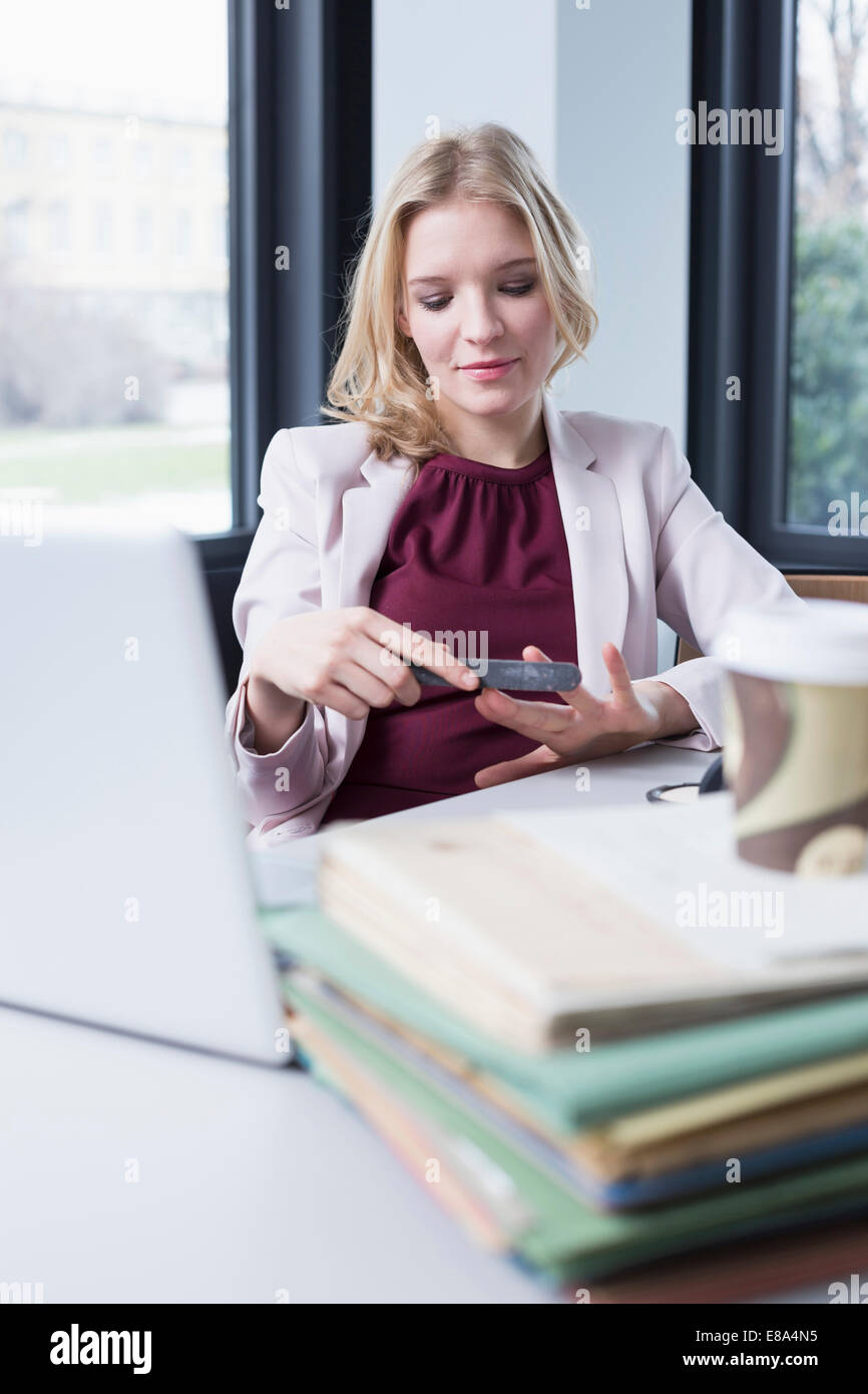 Business woman filing nails office hi-res stock photography and images ...