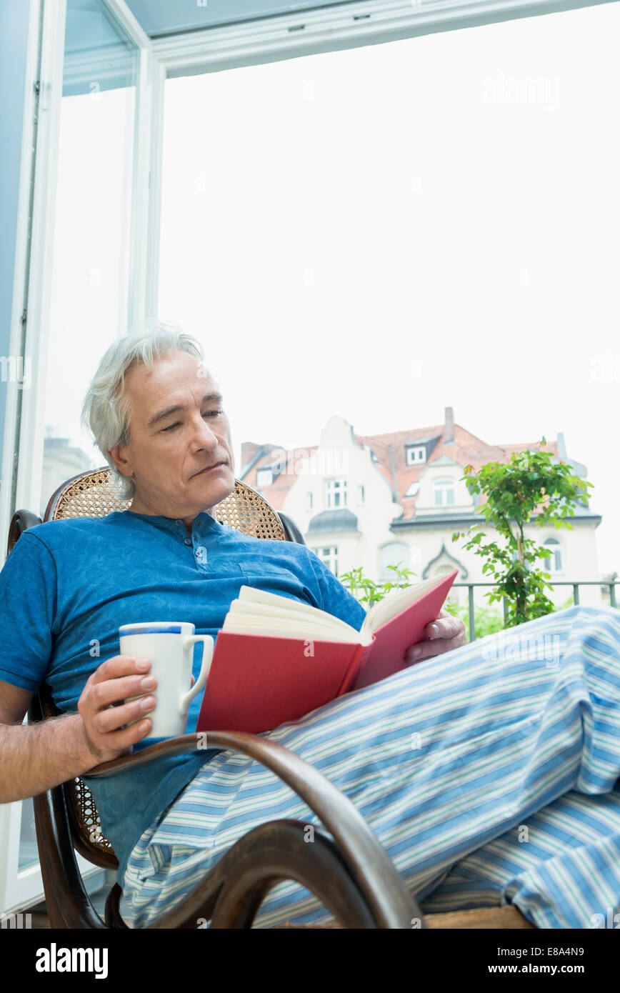 Man sitting on rocking chair hi-res stock photography and images - Alamy