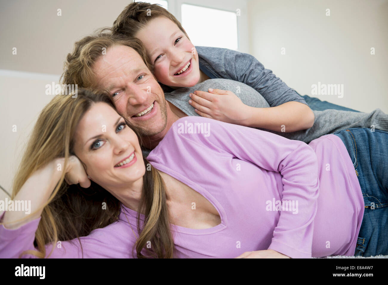 Happy family relaxing at home Stock Photo - Alamy