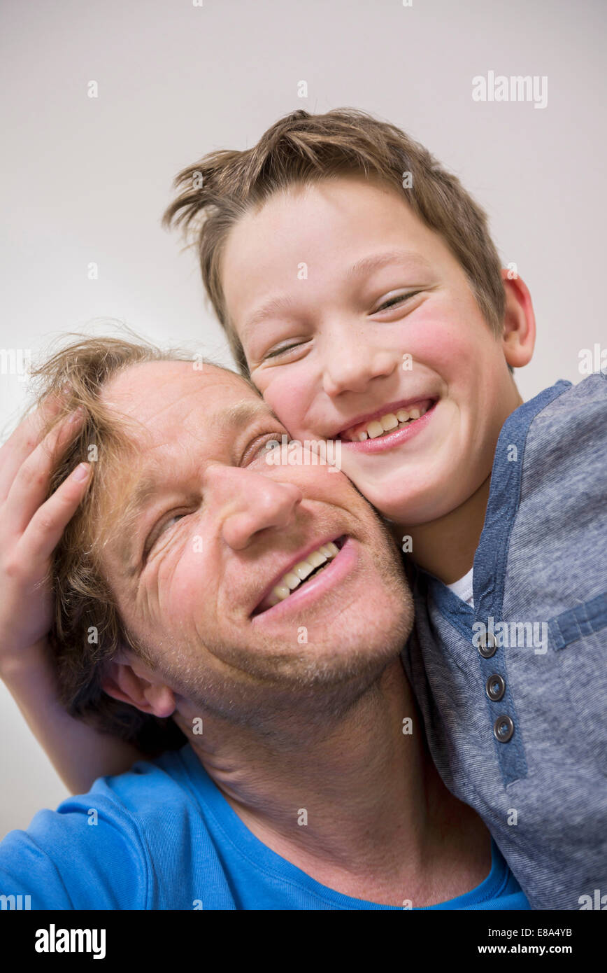 Happy boy hugging father Stock Photo - Alamy