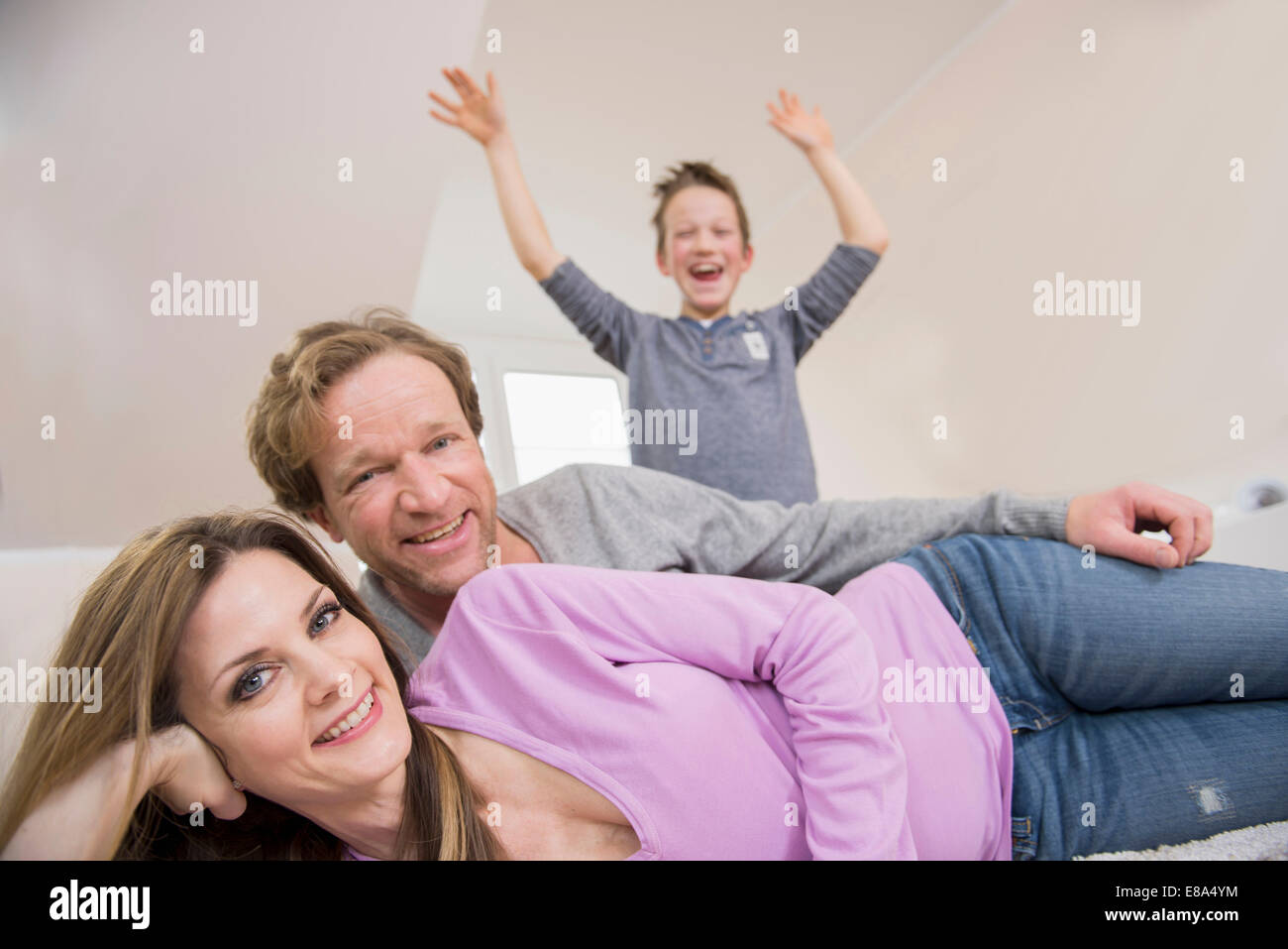 Happy family relaxing at home Stock Photo - Alamy
