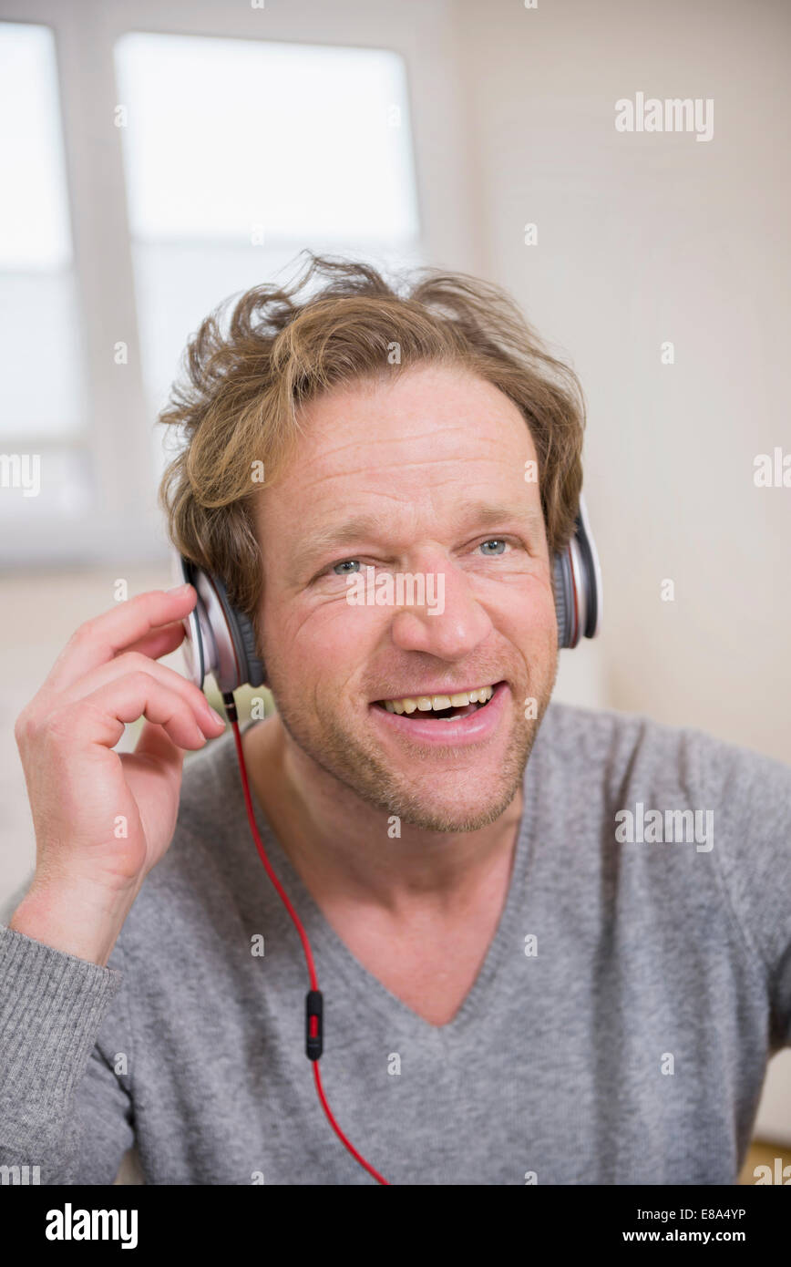 Smiling man listening to music Stock Photo - Alamy