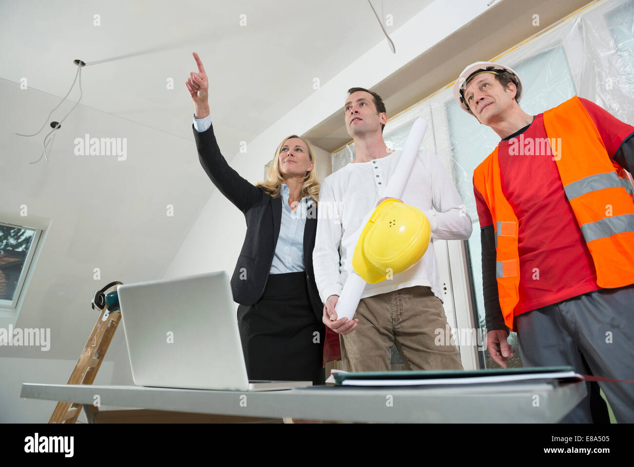 Female architect, construction manager and construction worker at ...