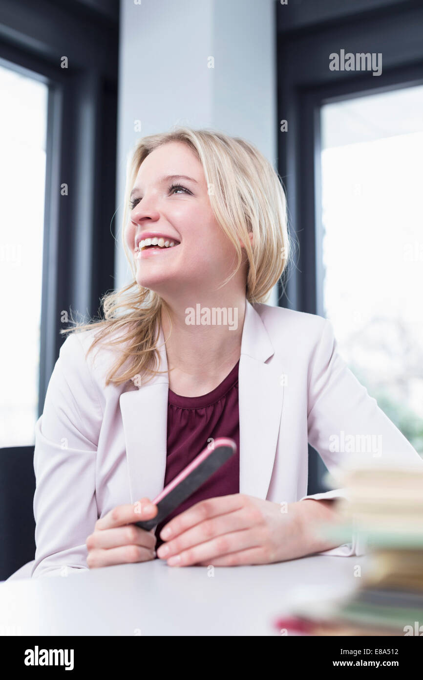 businesswoman filing her nails in office Stock Photo - Alamy
