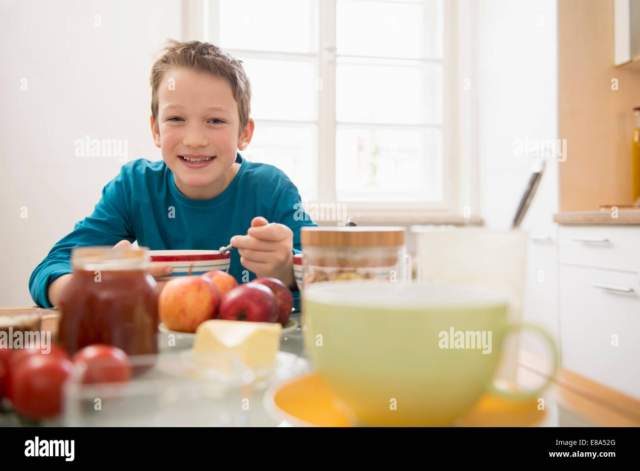 Boy having breakfast in kitchen Stock Photo - Alamy