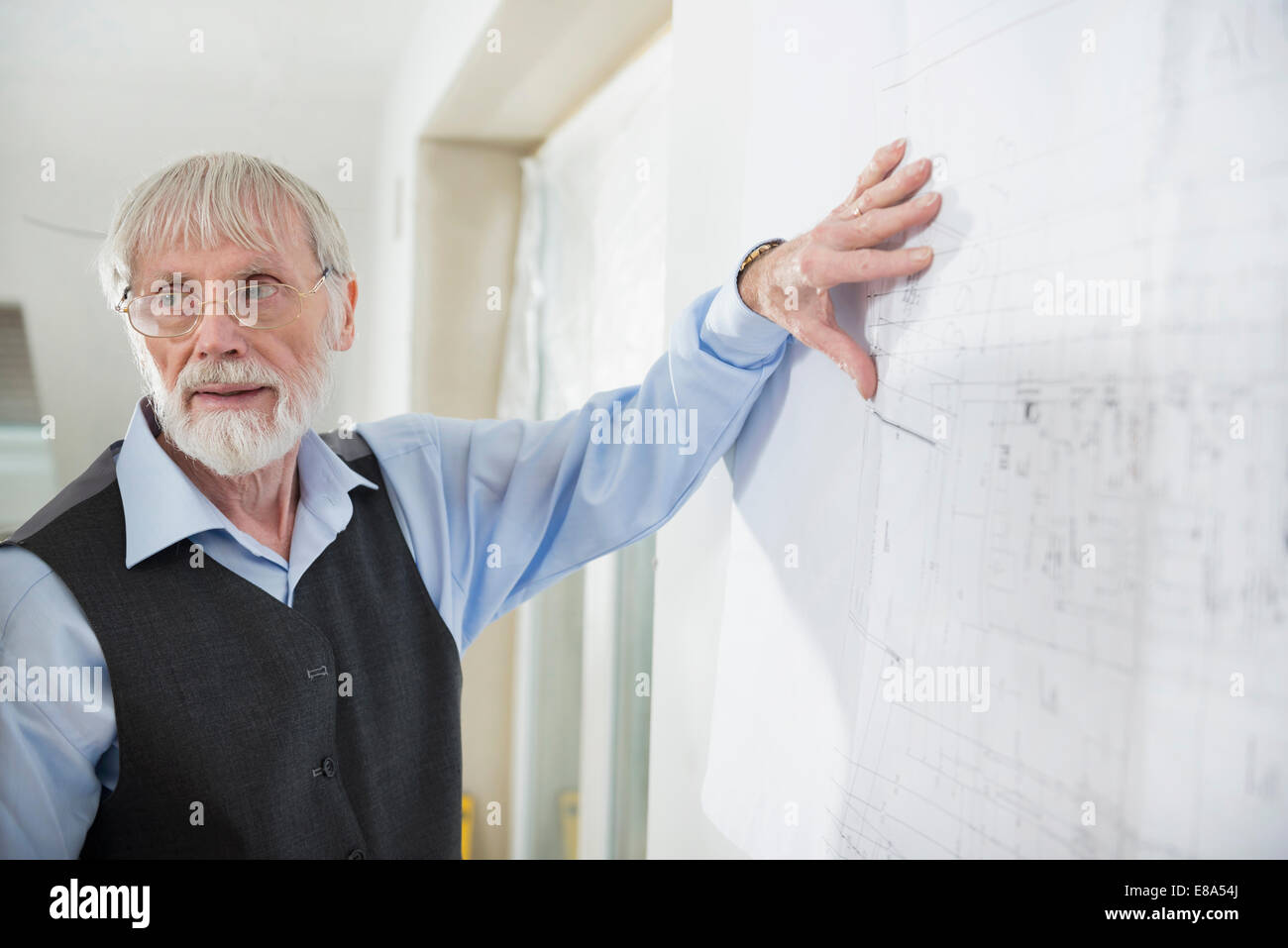 Architect presenting construction plan Stock Photo - Alamy