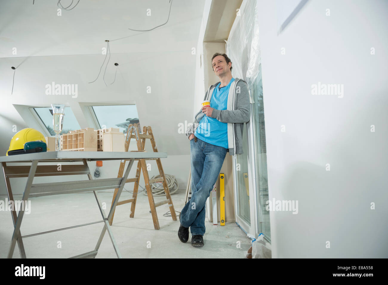 Man at construction site of new building Stock Photo - Alamy