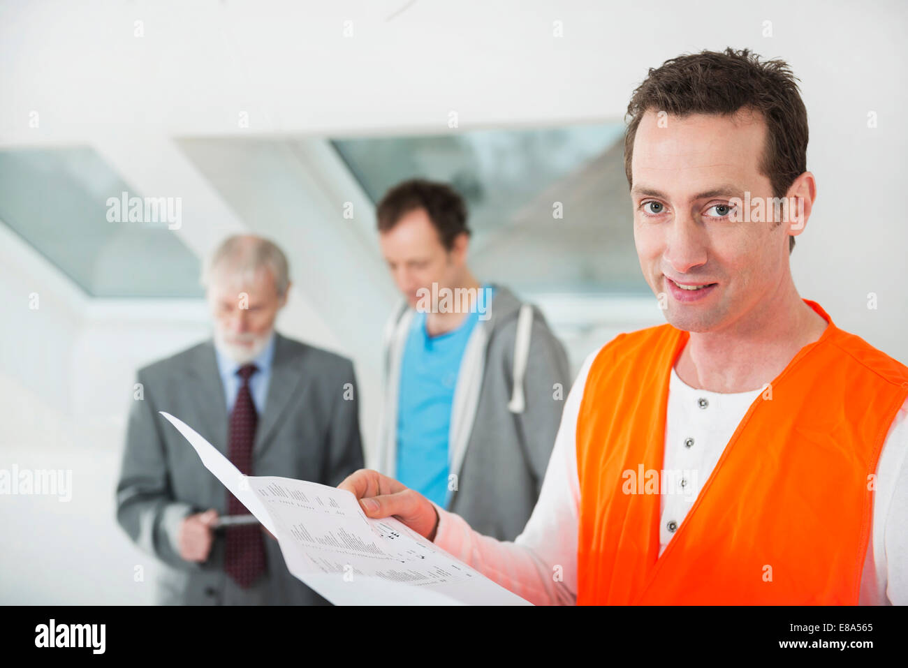 Architect, building owner and construction worker at construction site ...