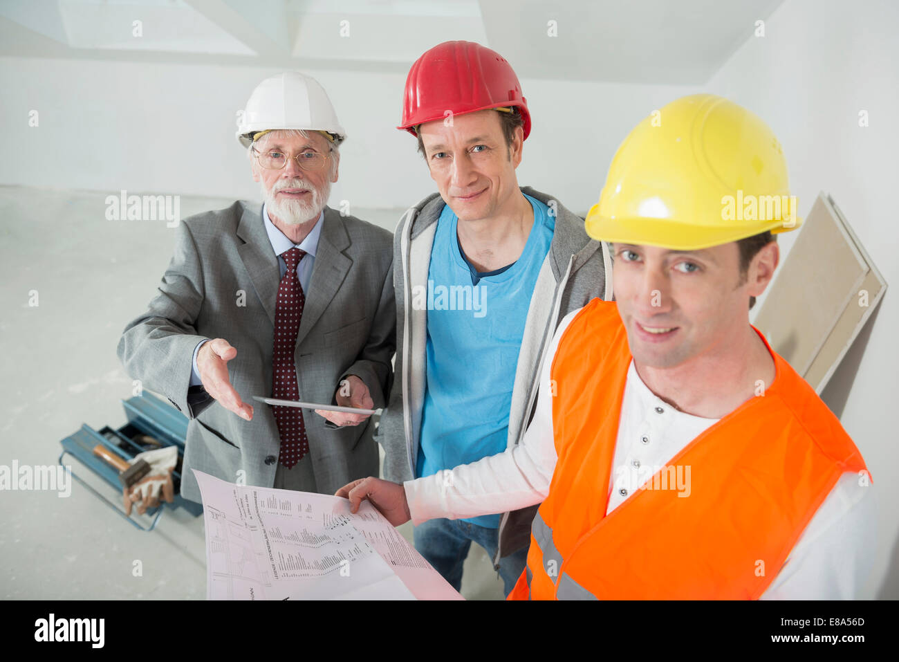 Architect, building owner and construction worker at construction site ...