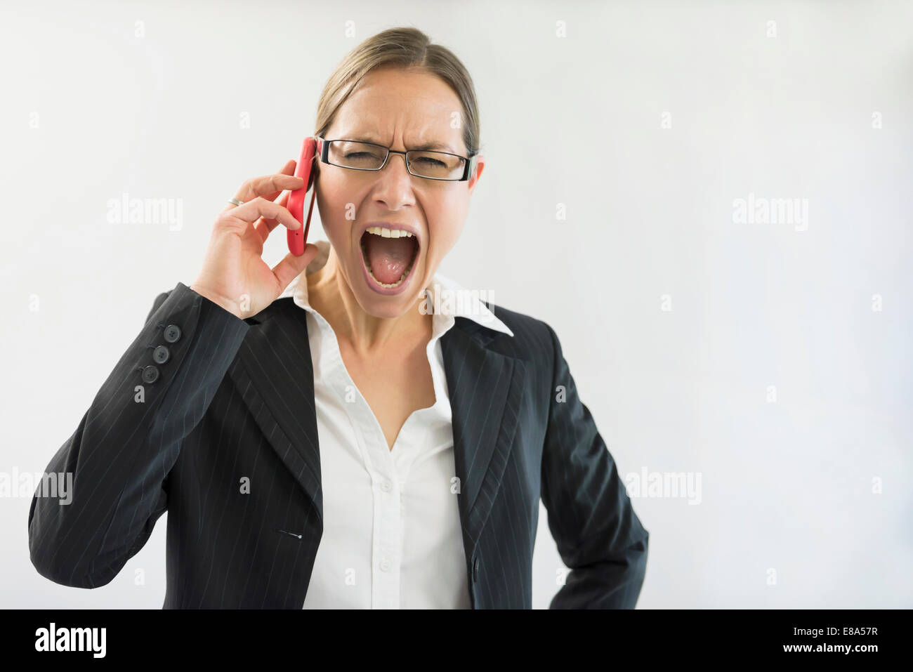 businesswoman in black suit shouting on smart phone Stock Photo - Alamy