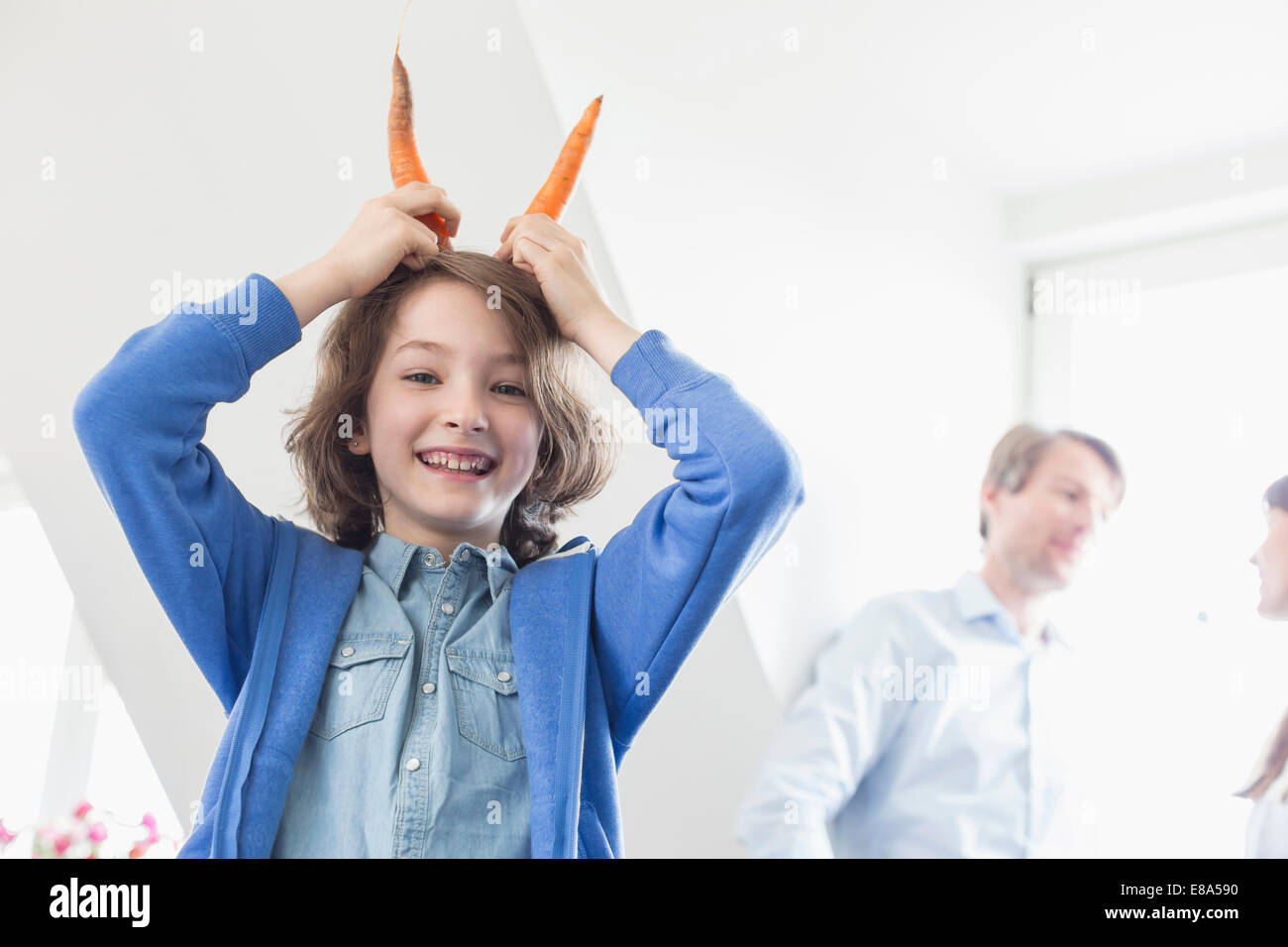 Portrait of girl making devil with carrots as horns, smiling Stock ...