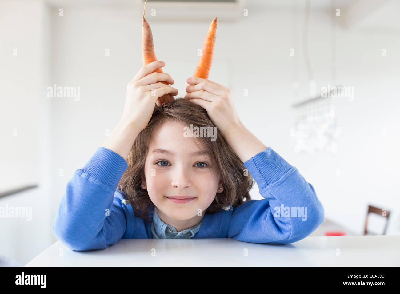 Portrait of girl making devil with carrots as horns, smiling Stock ...