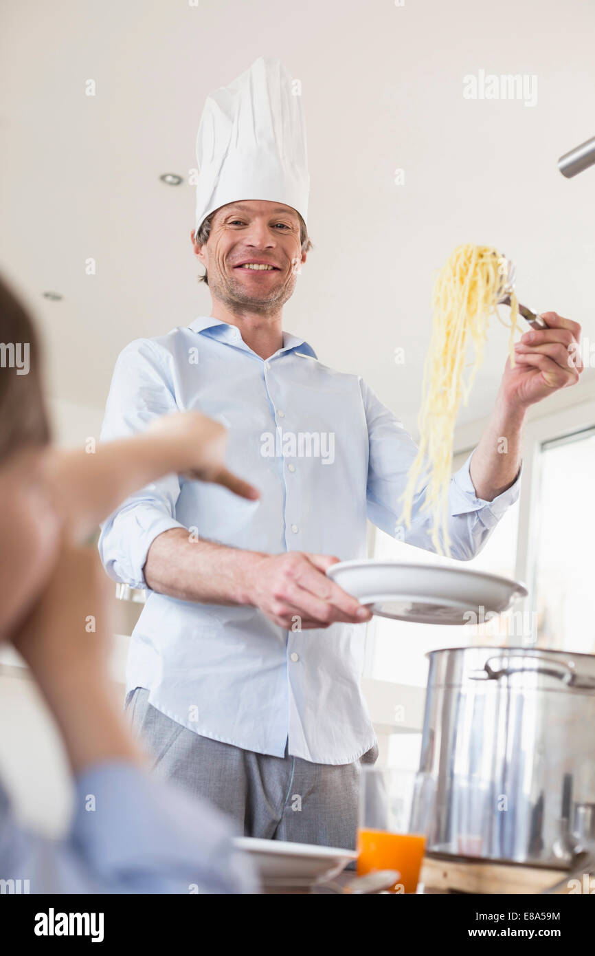 Father hand overing meal to son Stock Photo - Alamy