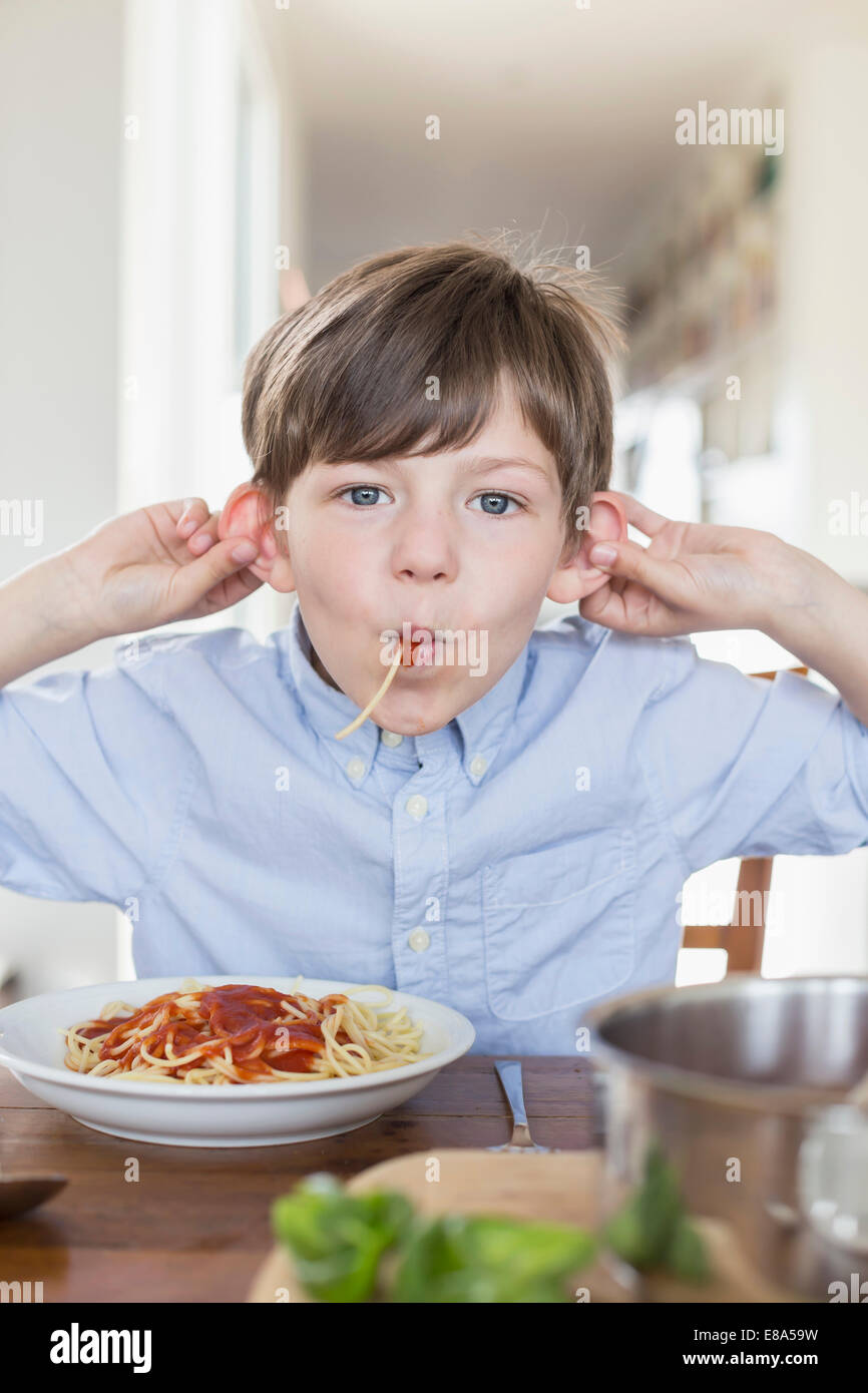 Boy eating spaghetti Stock Photo - Alamy