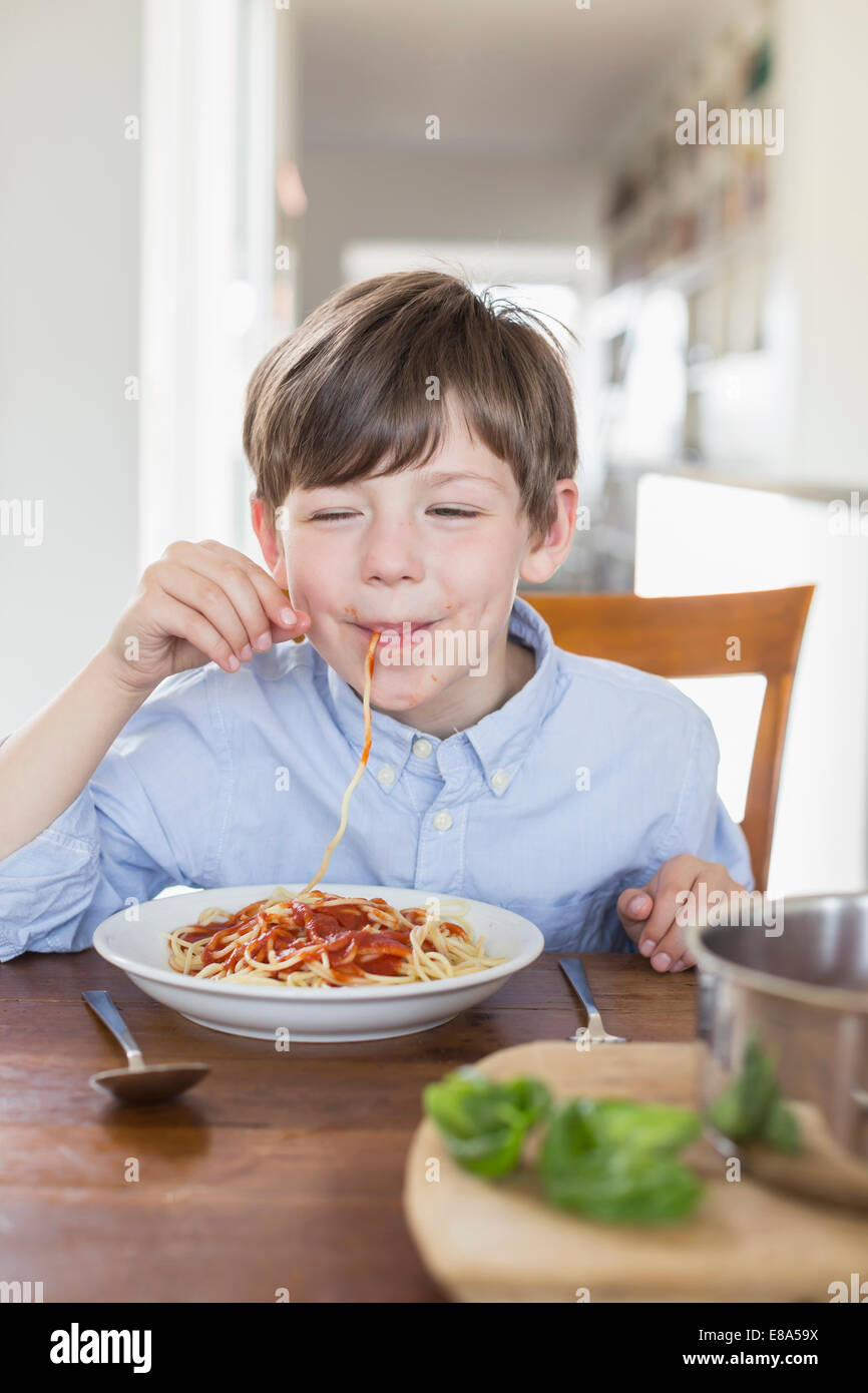 Boy eating spaghetti Stock Photo - Alamy