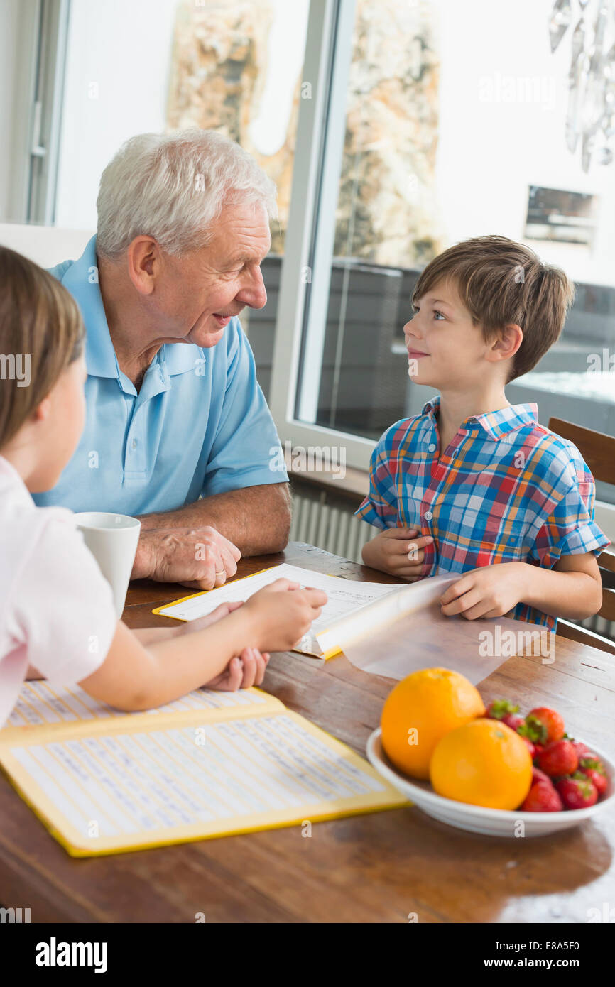 Grandson grandfather doing homework home hi-res stock photography and ...