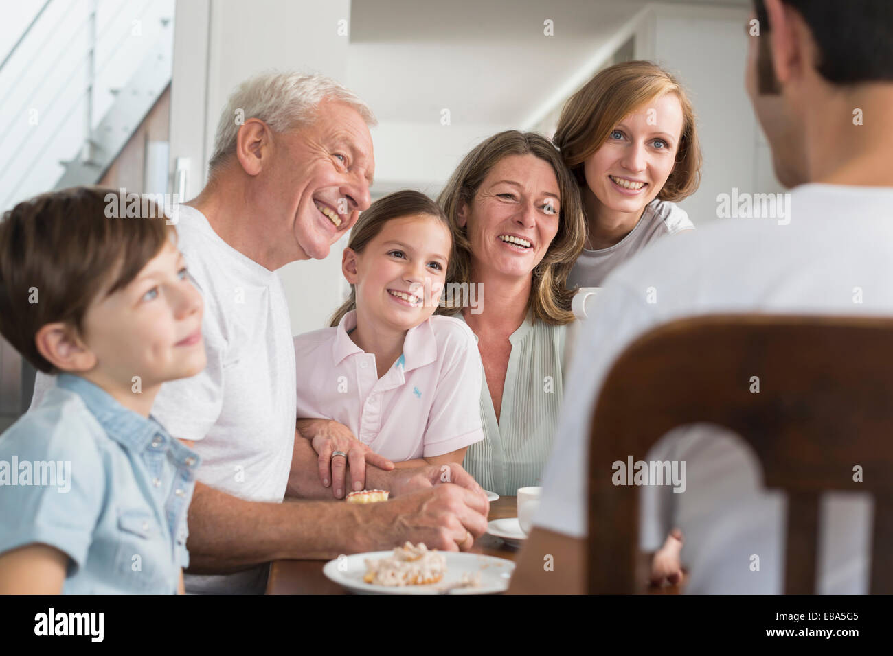 Extended family at table eating cake Stock Photo - Alamy