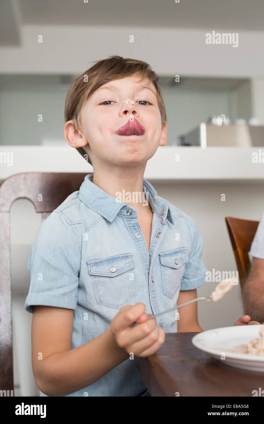 Playful boy with cake in his face Stock Photo - Alamy