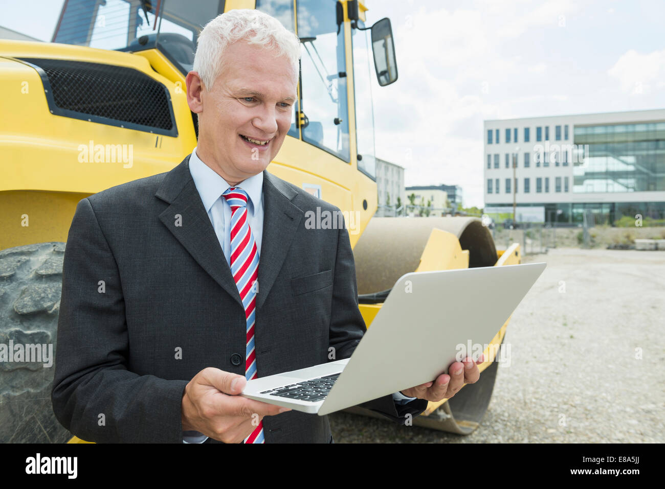 businessman with laptop on construction site Stock Photo - Alamy