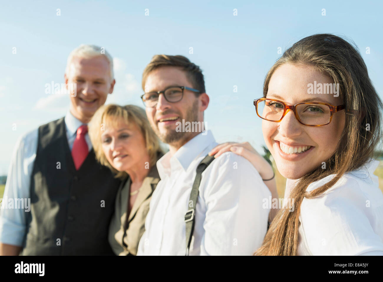 Smiling young woman with three other people outdoors, portrait Stock ...