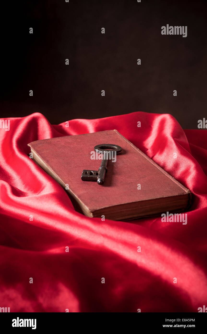 Old key on a red book Stock Photo - Alamy
